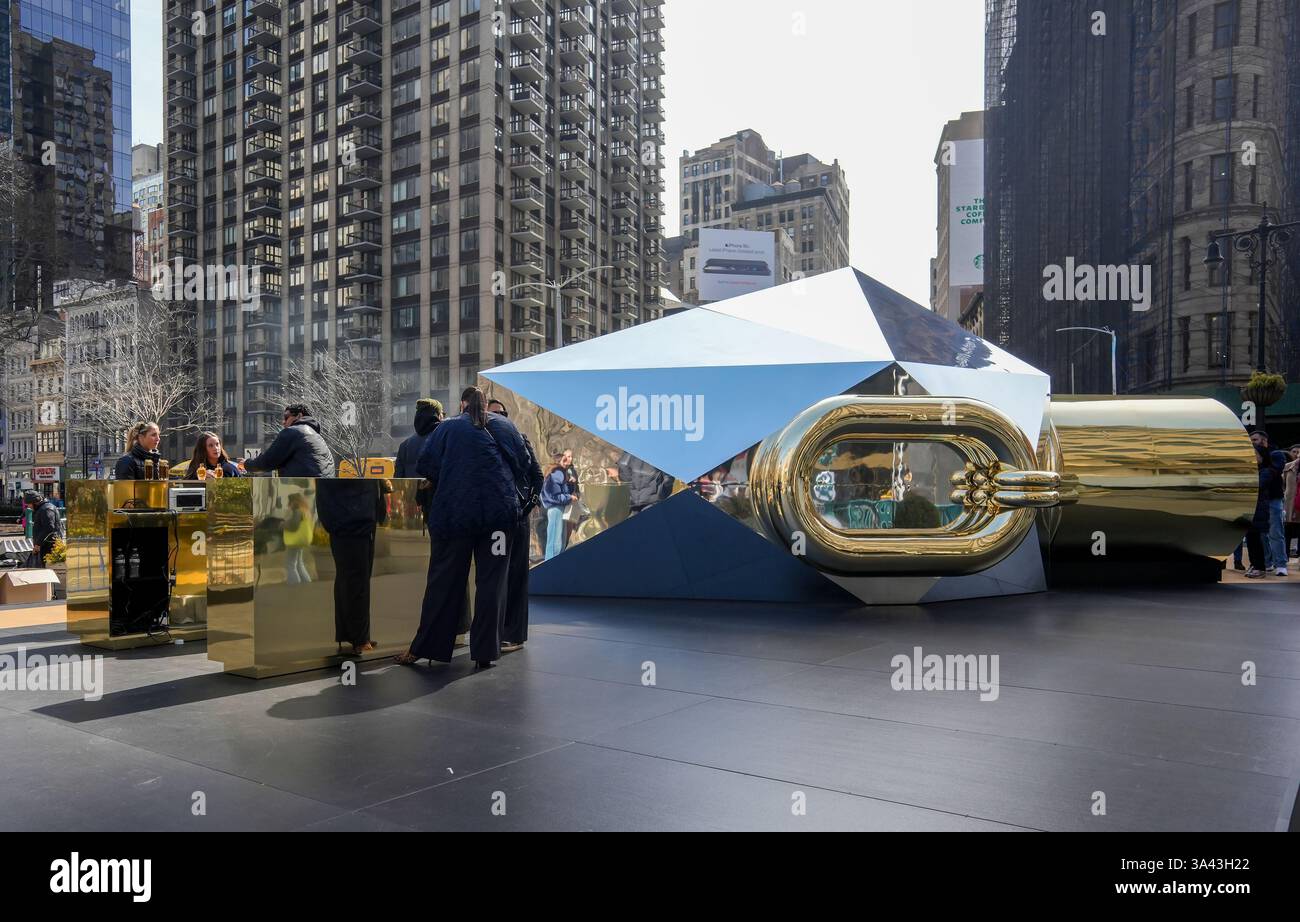 Visitors line up to enter a giant over-turned perfume bottle at the ...