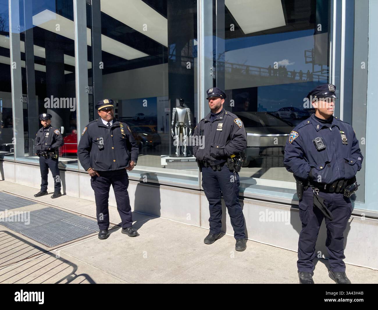 Police during a “Tesla Takedown” outside of the Tesla showroom in the ...