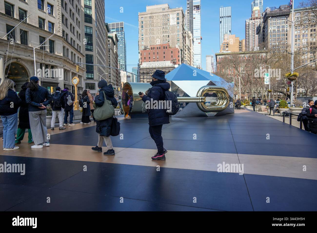 Visitors line up to enter a giant over-turned perfume bottle at the ...