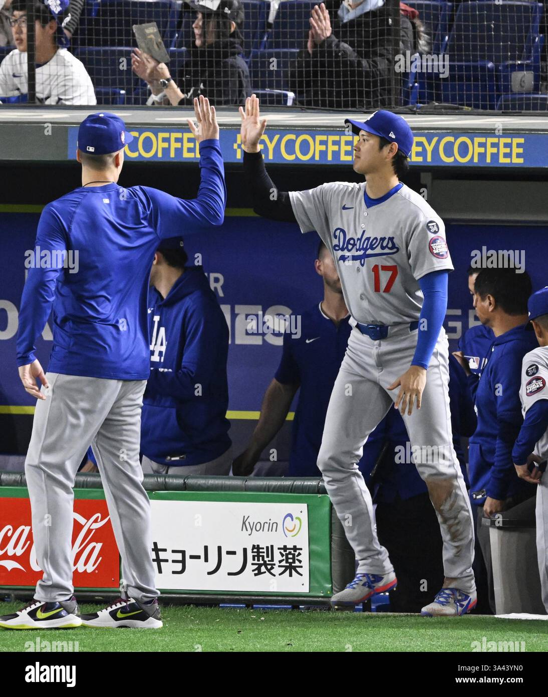 Shohei Otani (17) of the Los Angeles Dodgers high-fives with a teammate ...