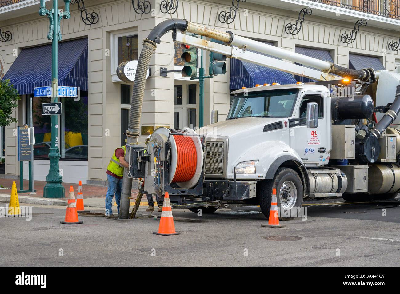 New Orleans, LA, USA - February 7, 2025: Workers uses a vacuum and ...