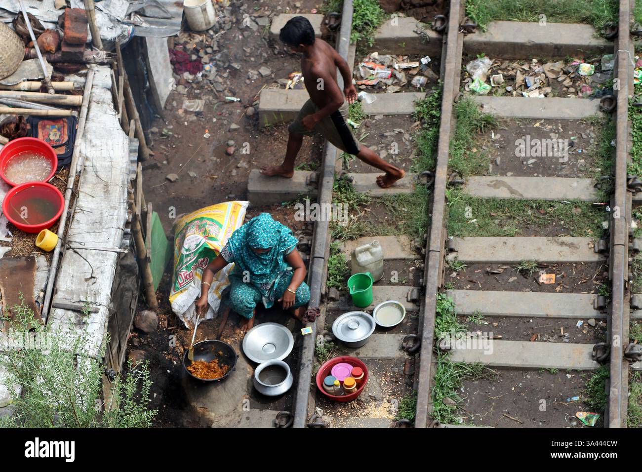 May 27, 2014 - Dhaka,Bangladesh:.A slum women cooking food on rail line ...