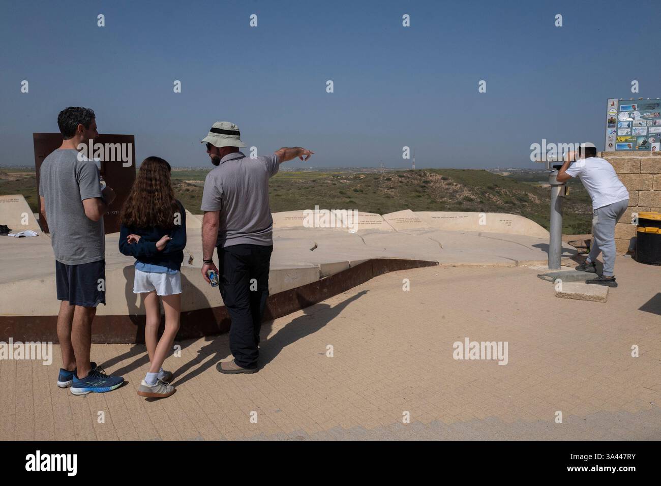 Sderot, Israel. 18th Mar, 2025. An Israeli looks through binoculars ...