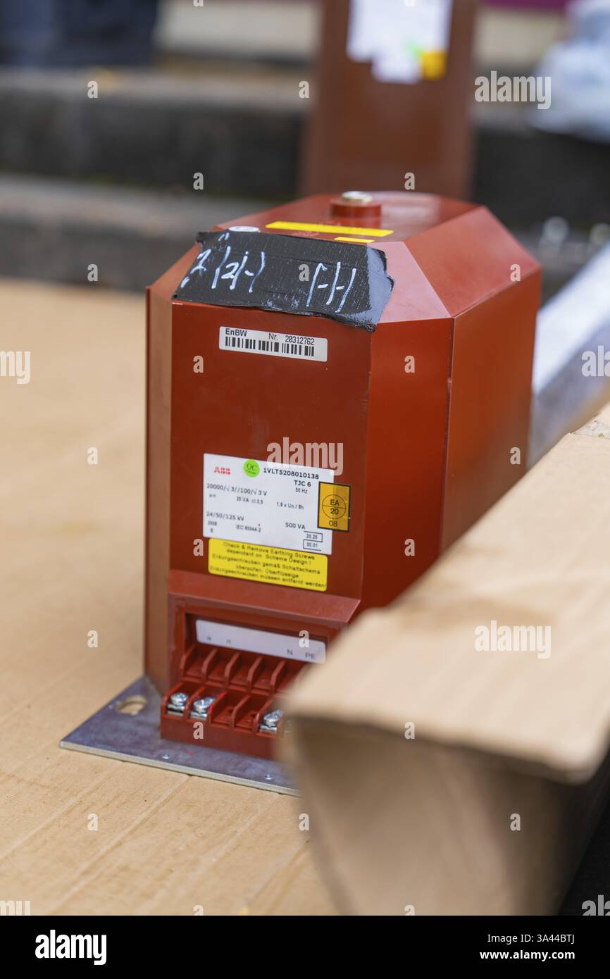 Red box with technical labels on a cardboard base, switch cabinet ...