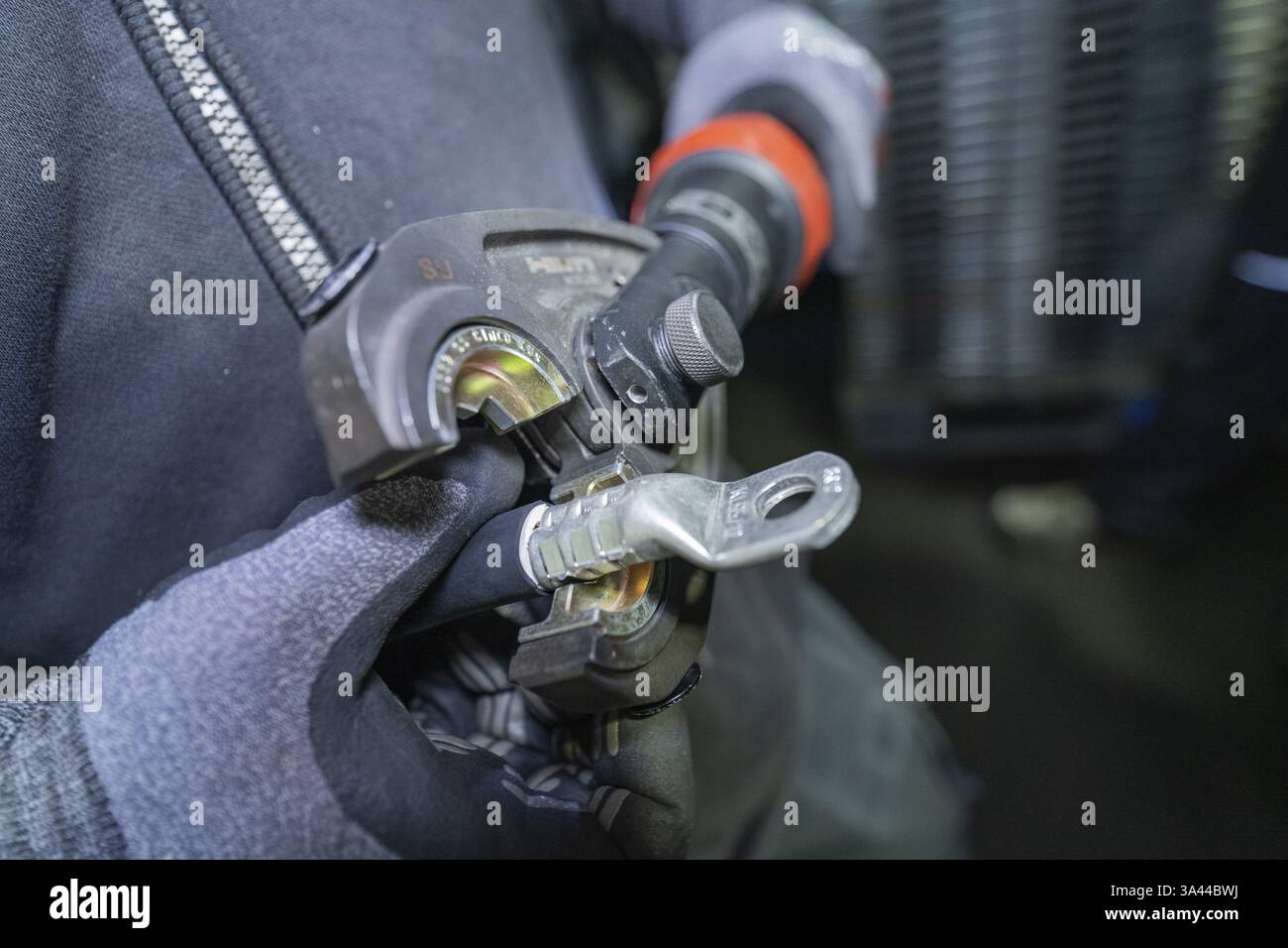 Tool in use for pressing an electrical connection, technology in focus ...