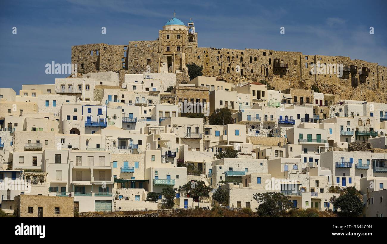 Stone fortress towers over a settlement of white cubic houses, Querini ...