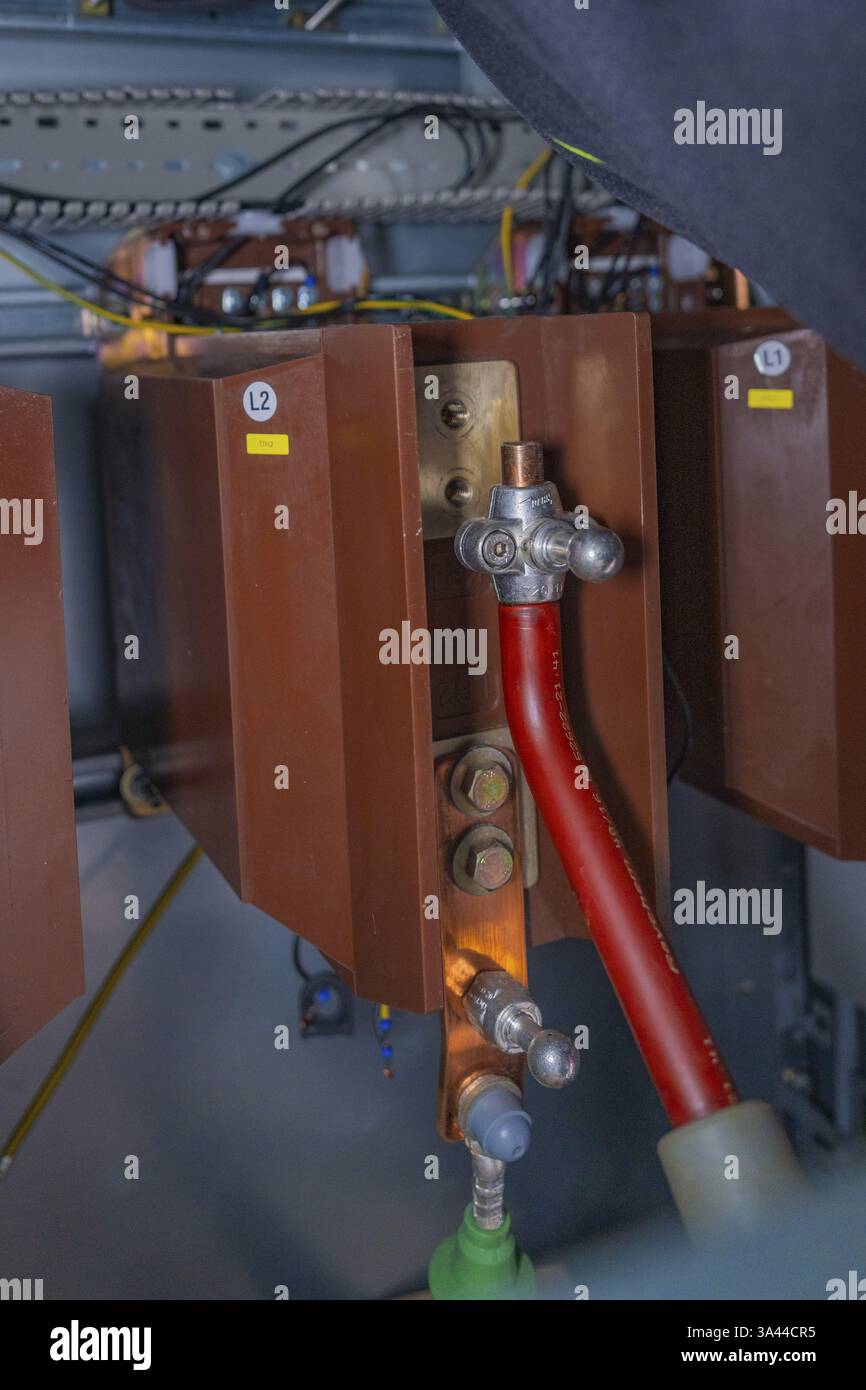 Electrical control panel with metallic components and cables, switch ...