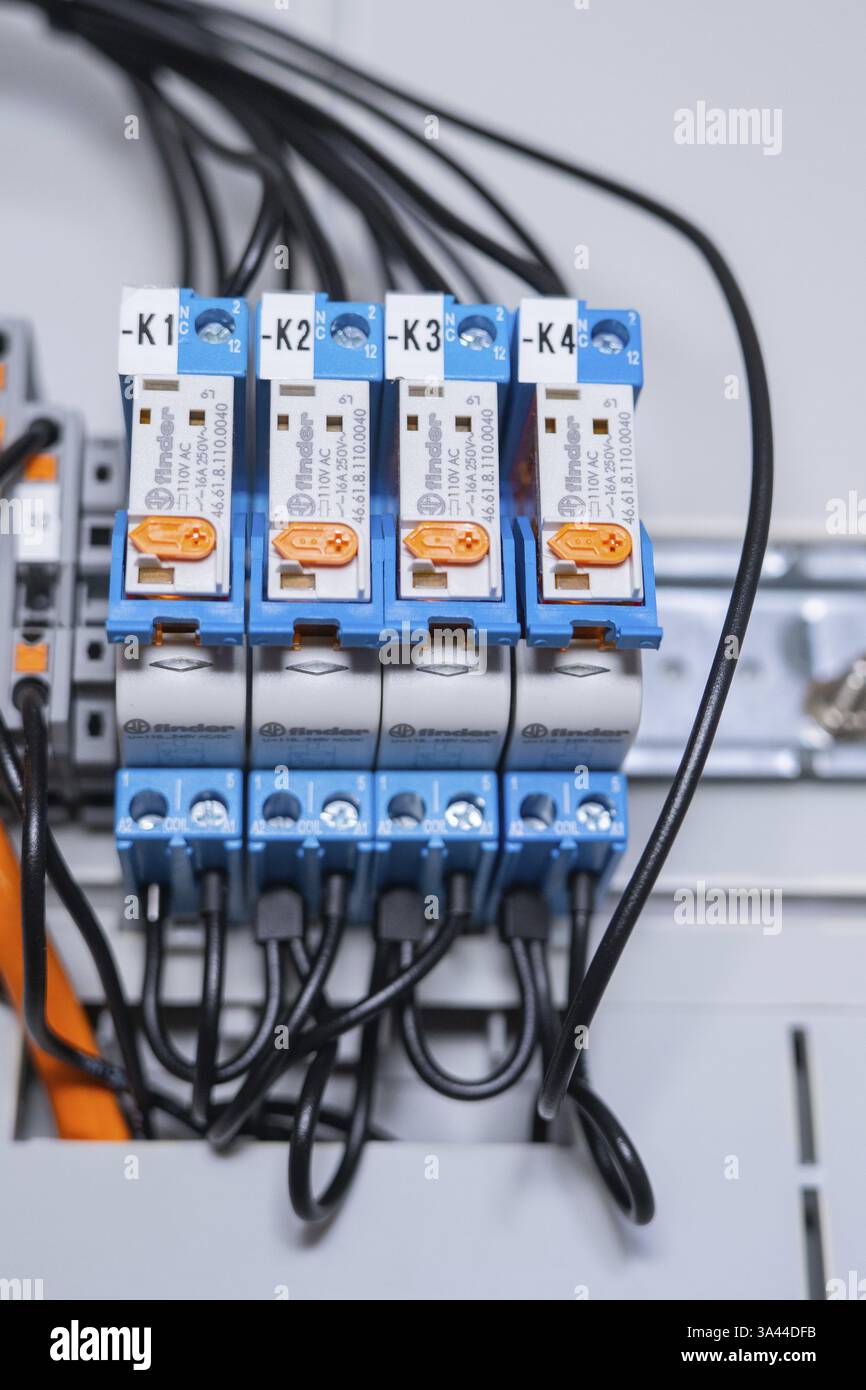 Four blue relays connected in series, showing structural complexity and ...