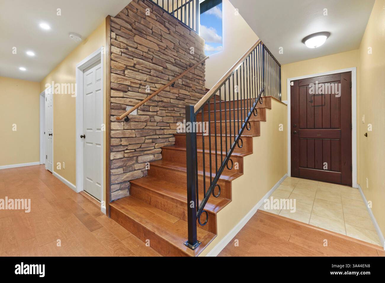 A beautifully designed wooden staircase featuring a stylish metal ...