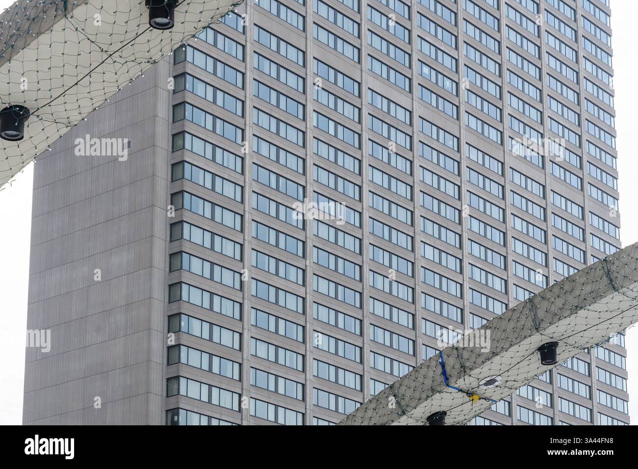 Facade of a modern building framed by the arches of Nathan Phillips ...