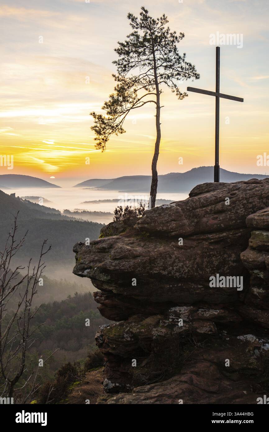 Summit cross on a sandstone rock in the middle of the forest. Landscape ...