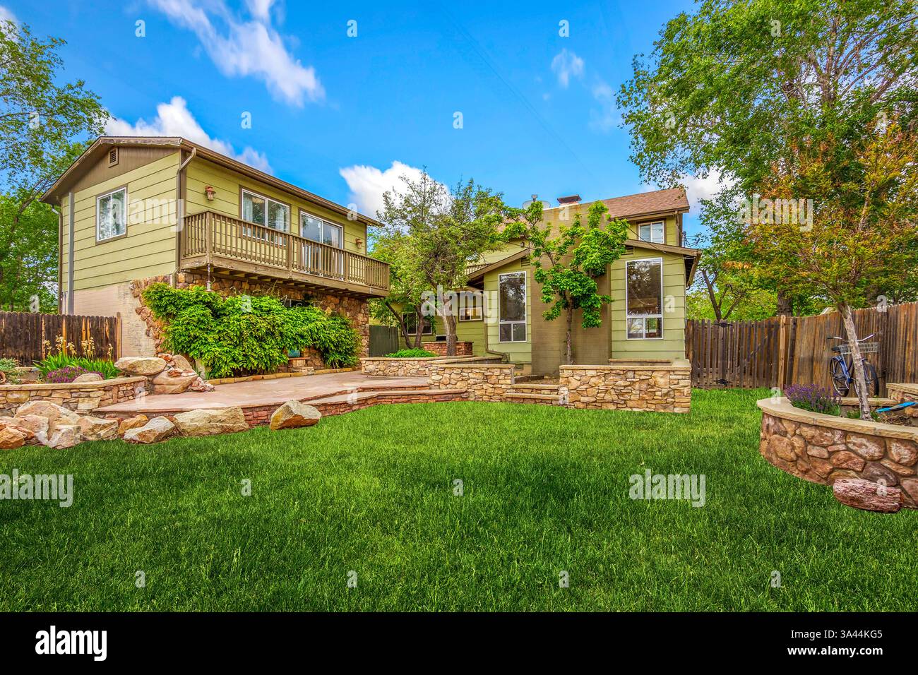 There is an impressive large house that features a spacious lawn ...