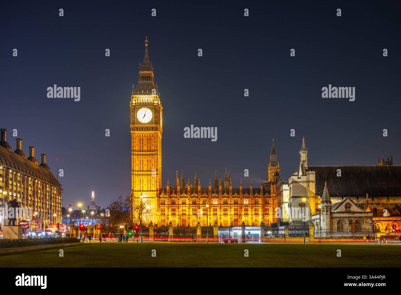 Big Ben stands tall against the night sky, glowing with golden light ...