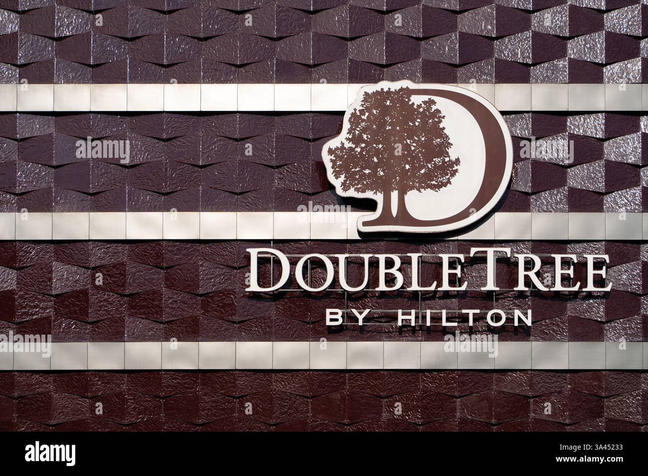 A view of a sign outside the Doubletree By Hilton Hotel. Logo on the ...