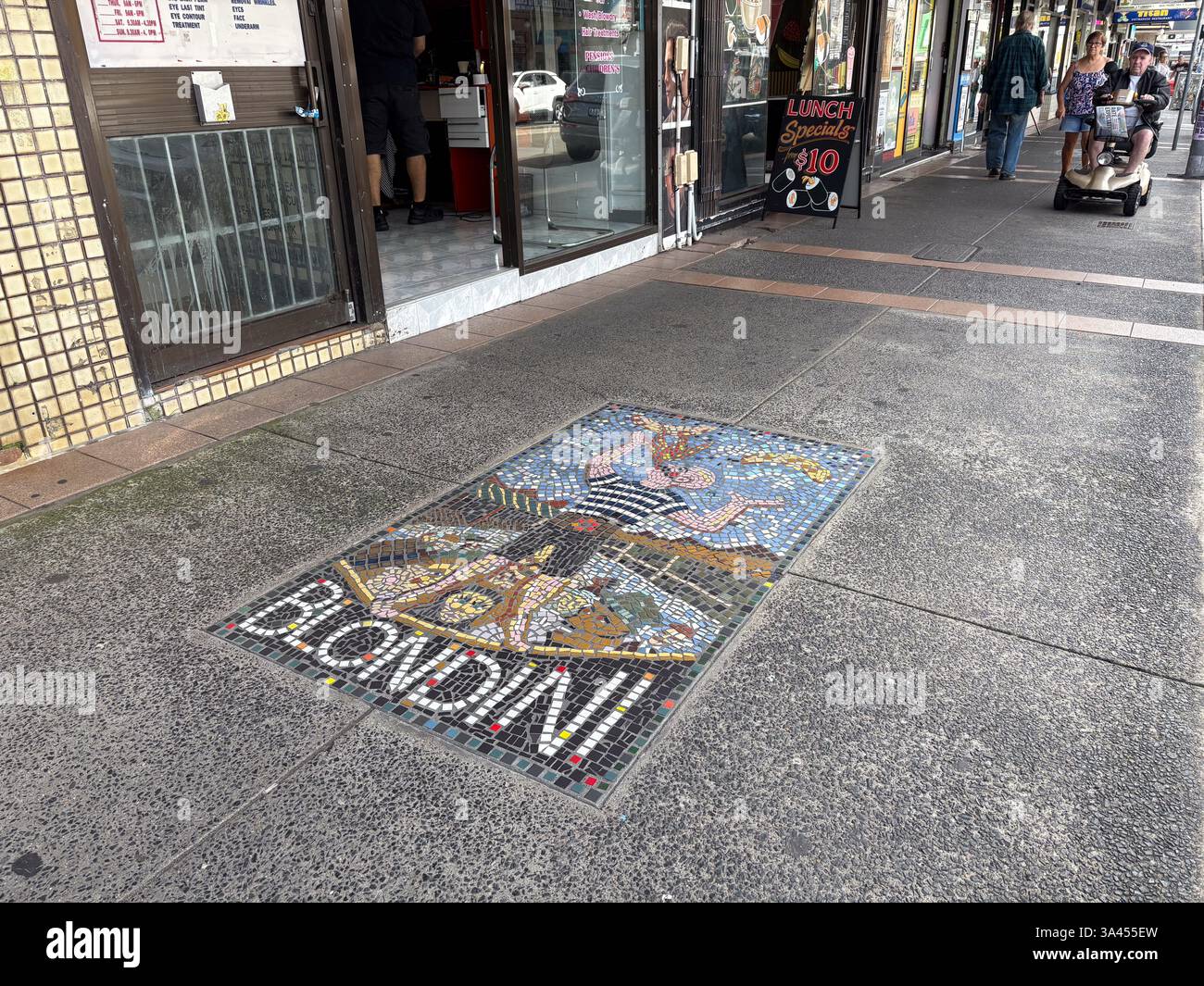 Side view of the sidewalk and street art on the street. Marrickville ...