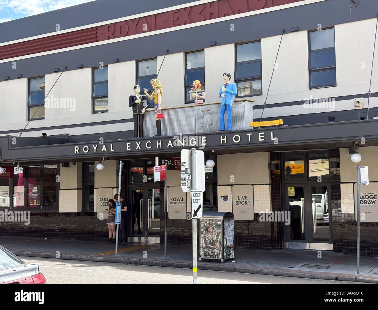Royal exchange hotel storefront featuring statues and business logo ...