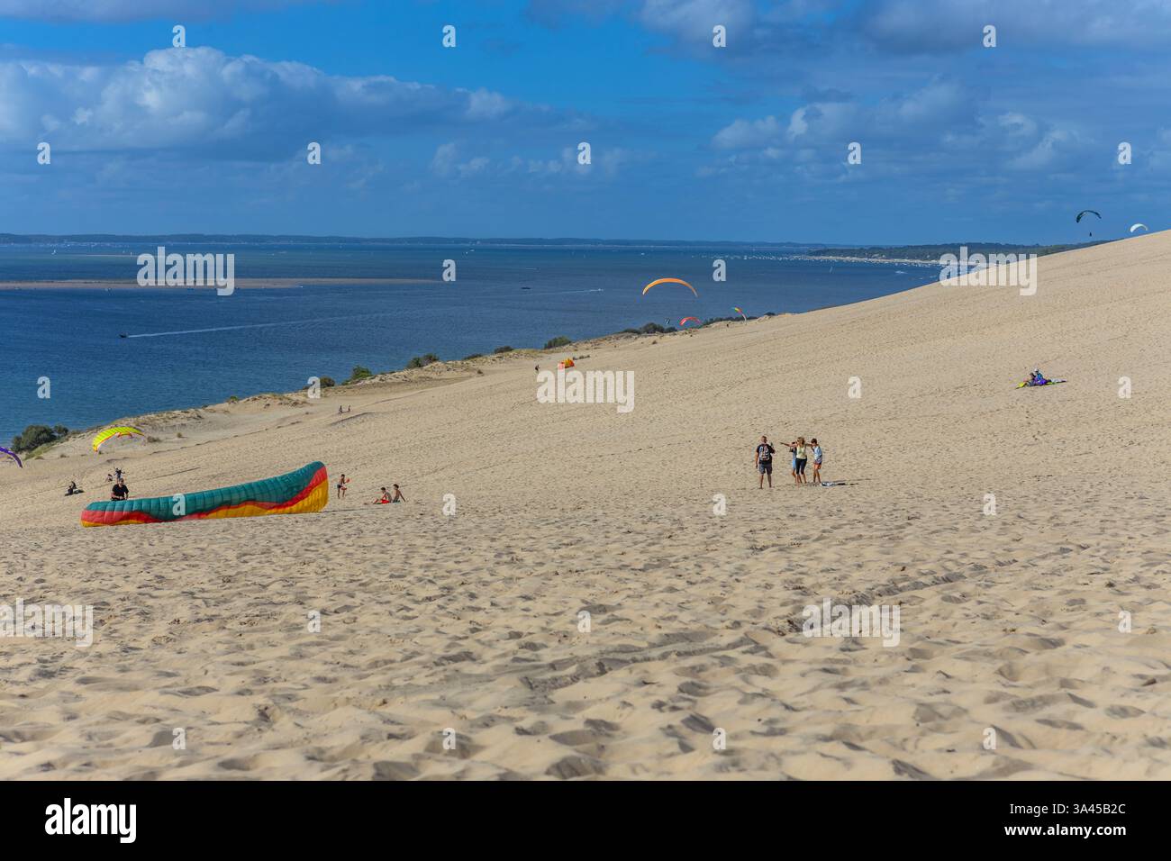 Dune of Pilat, France - August 14, 2024: People paragliding at the ...