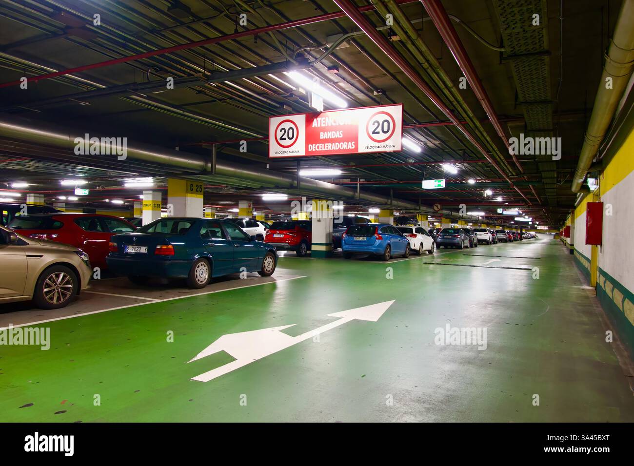 Large underground car park full of cars inside shopping mall El Corte ...