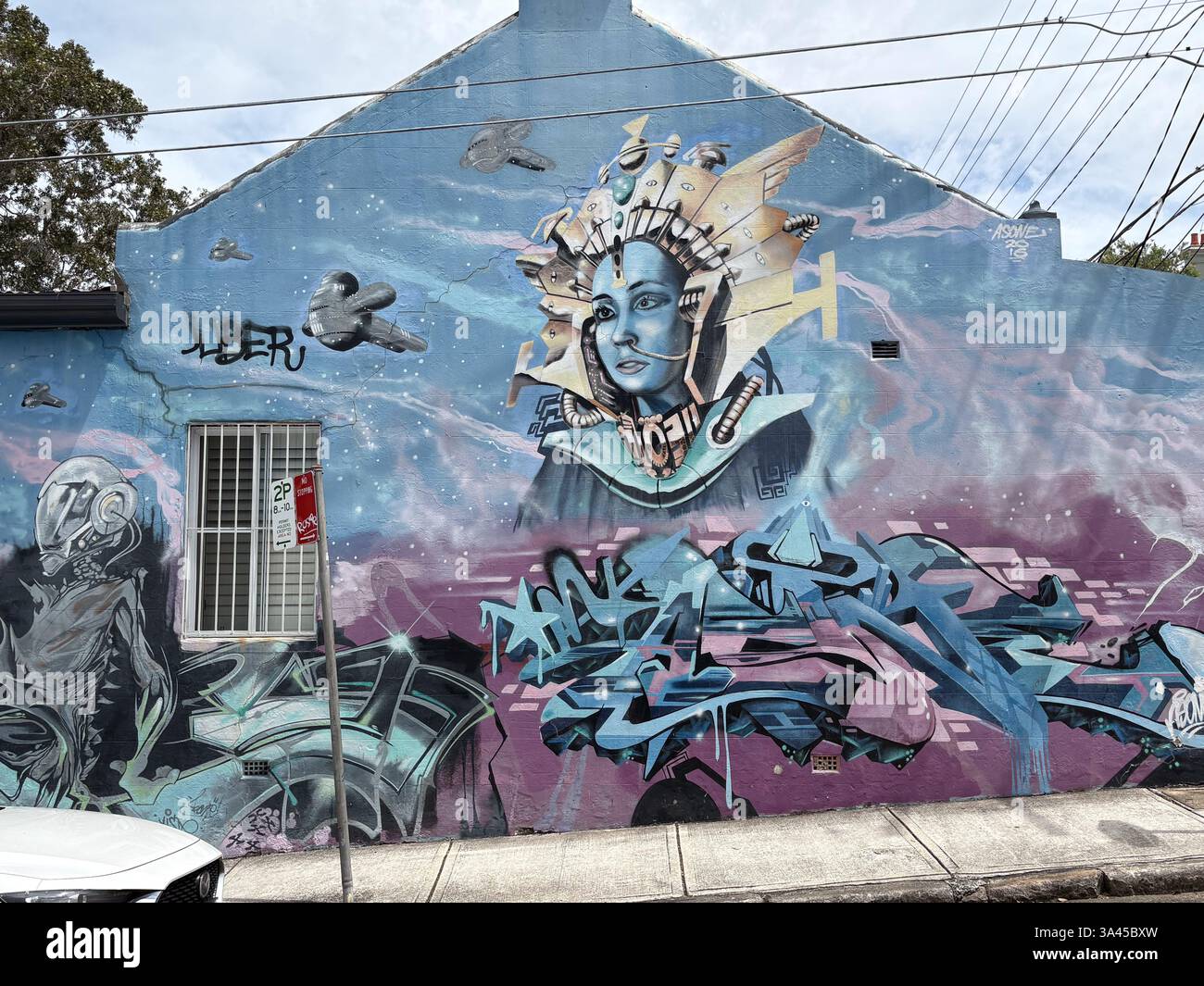 Large cosmic themed graffiti mural on a building in Sydney, featuring a ...