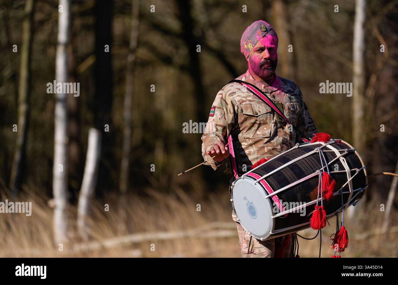 A Sikh soldier of the British Army plays a drum during the Holla ...