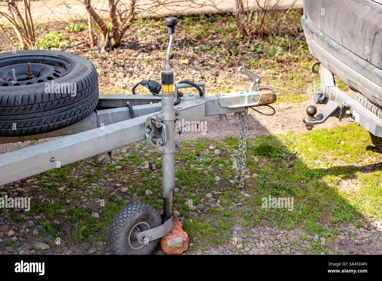 passenger car next to the trailer coupling, metal drawbar with spare ...