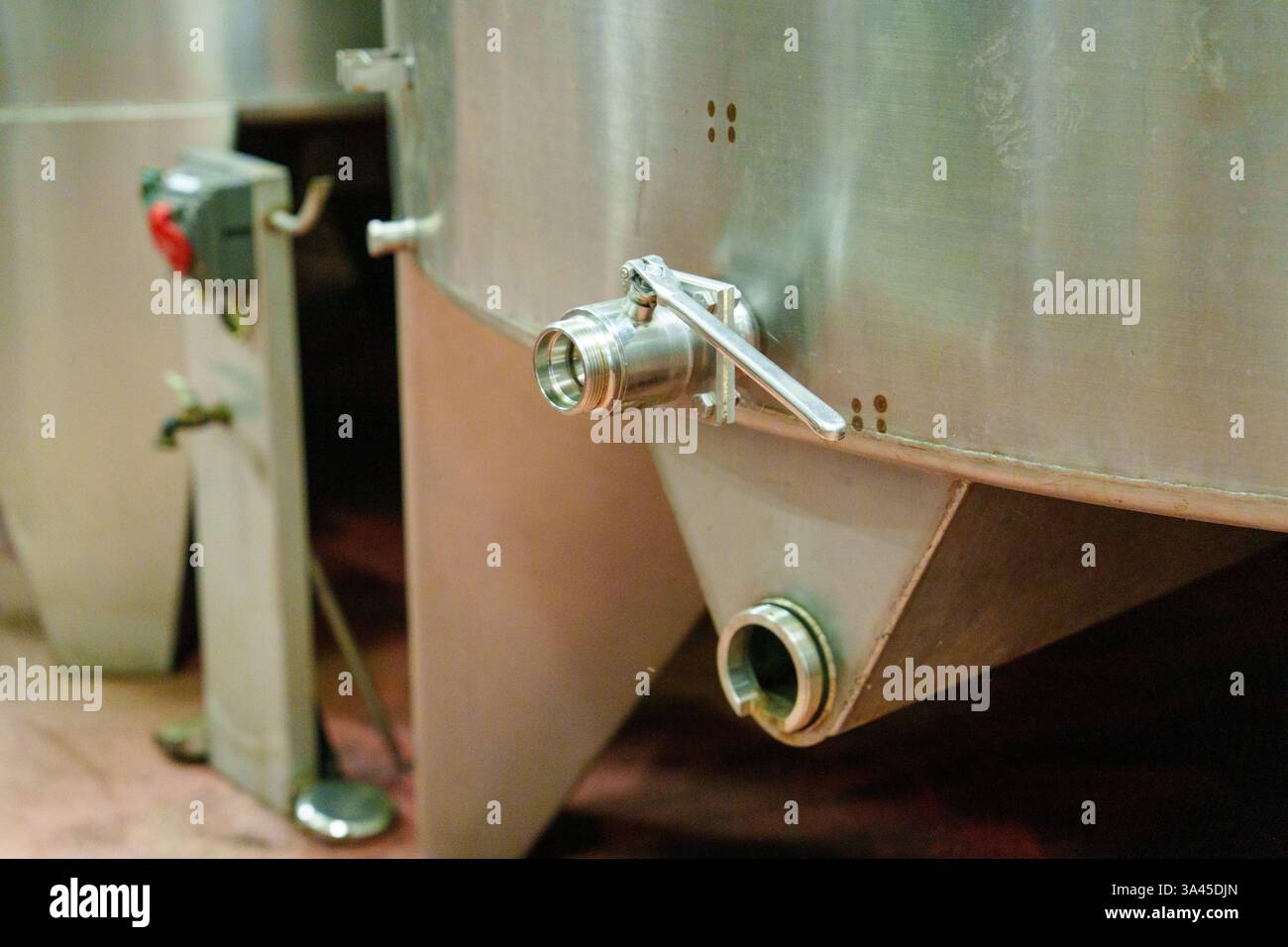 Detailed Close-up View of a Stainless Steel Tank Featuring a Valve and ...