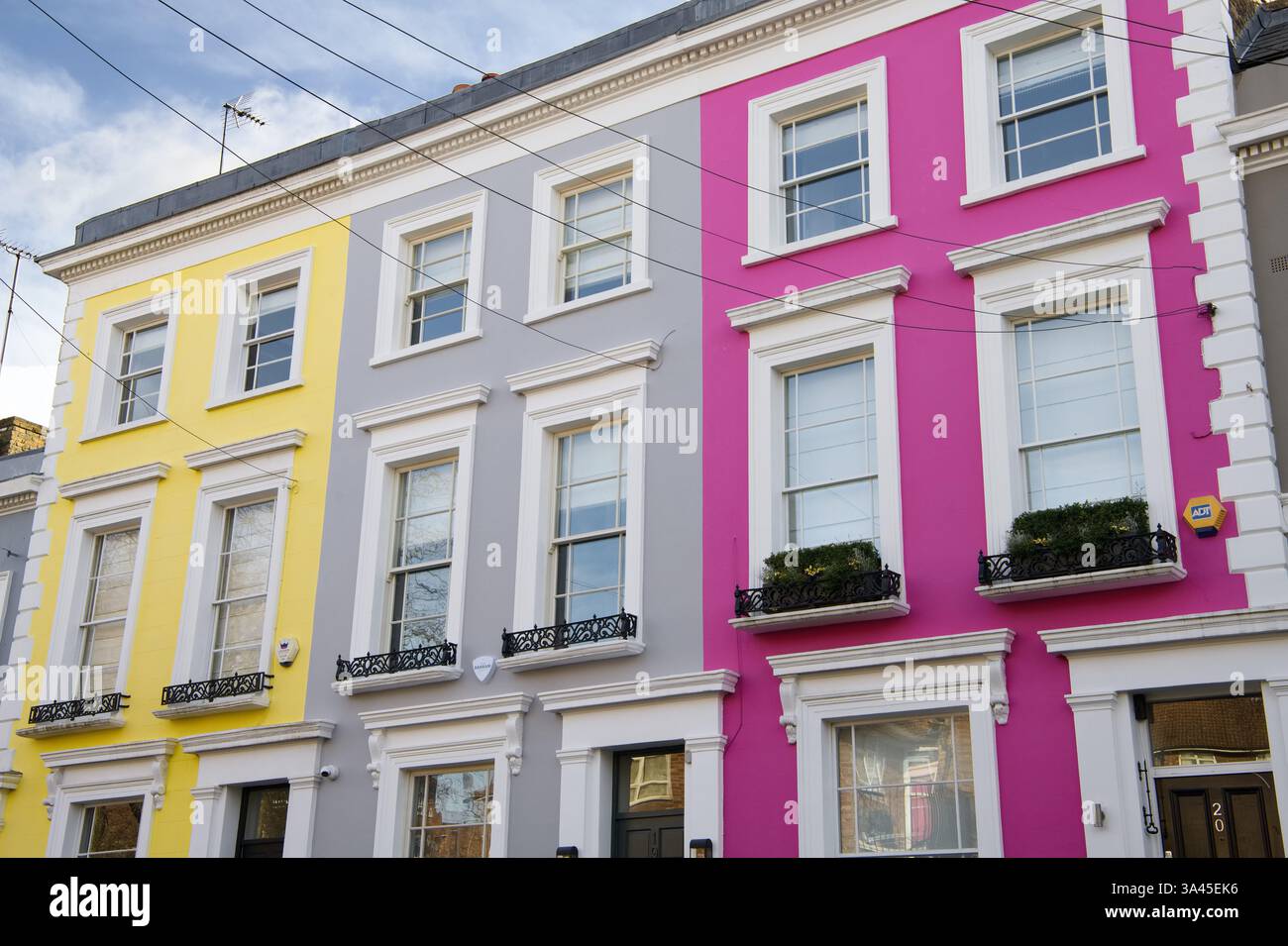 Upper floors of coloured houses with sash windows, Notting Hill, London ...