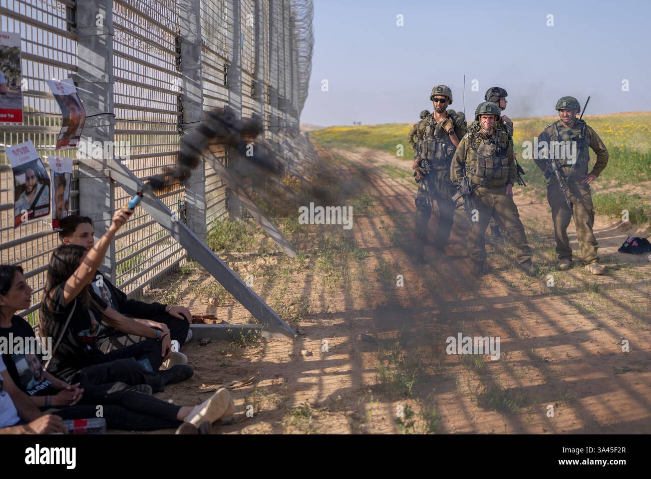 Nir Oz, Israel. 18th Mar, 2025. Israeli soldiers stand as hostage ...