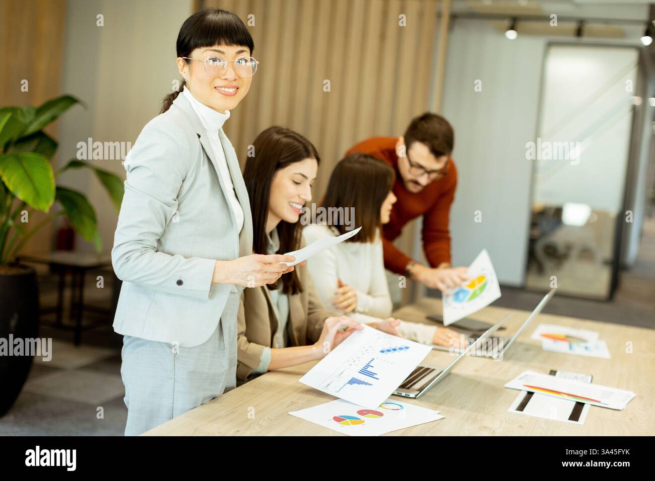 A diverse group of professionals engages in a dynamic brainstorming ...