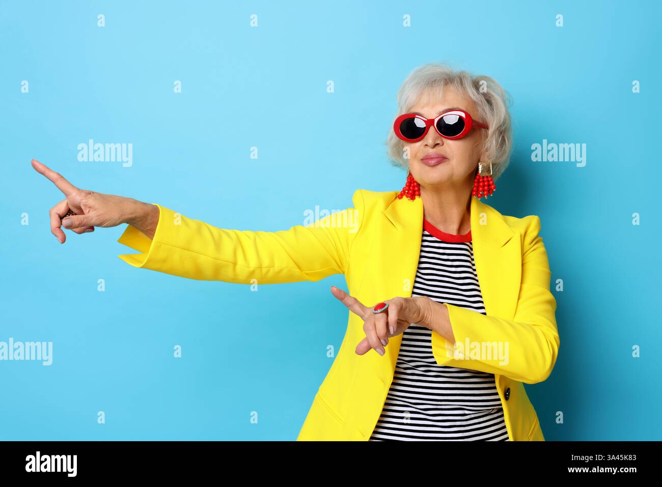 Portrait of cool grandmother on light blue background Stock Photo - Alamy