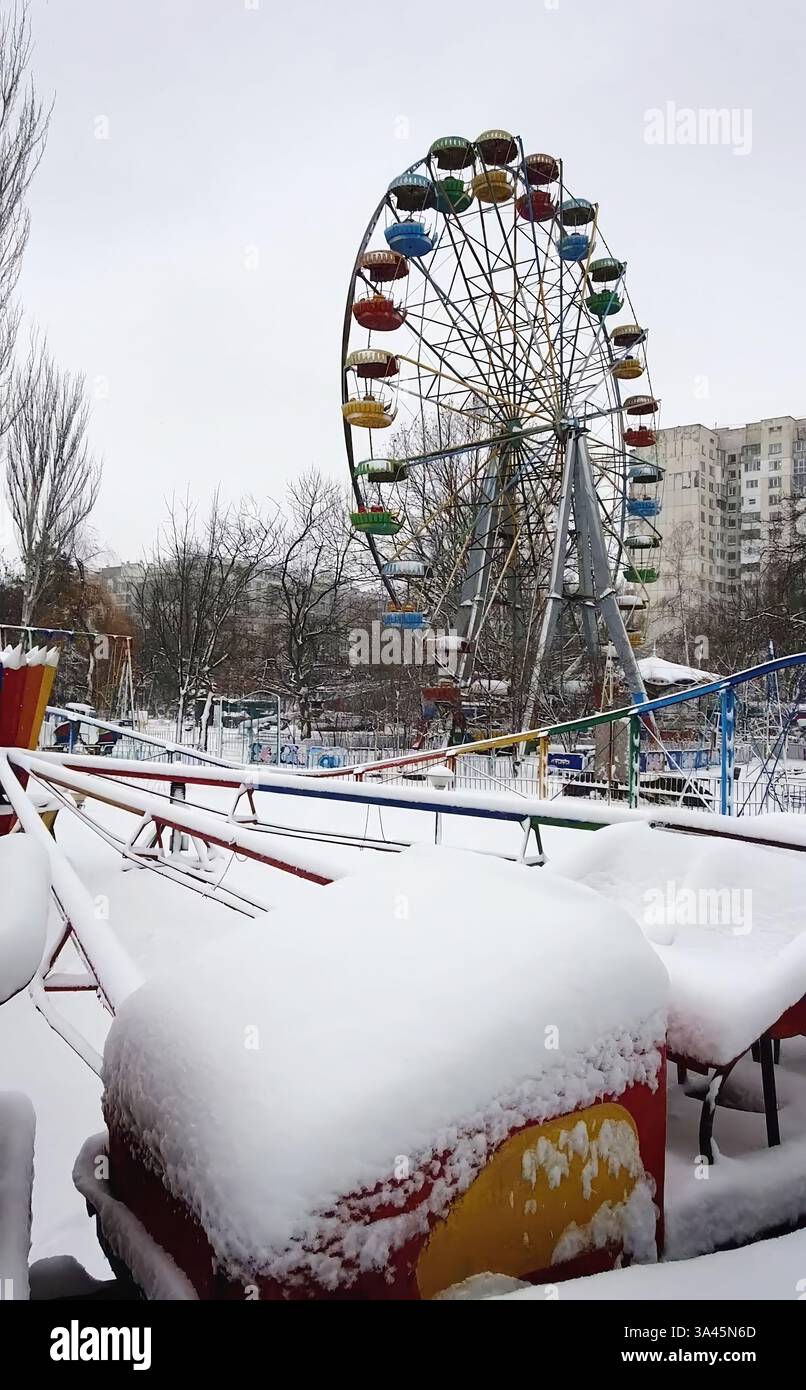 Abandoned amusement park. Old, rusty ferris wheel and rollercoaster ...