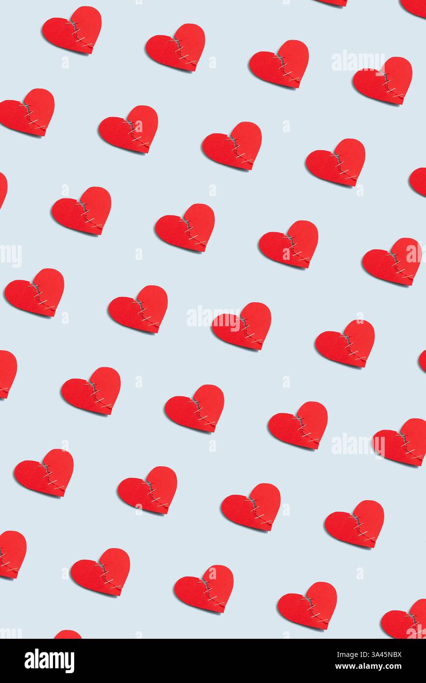 Red paper craft torn heart pattern on pastel blue background, vertical ...