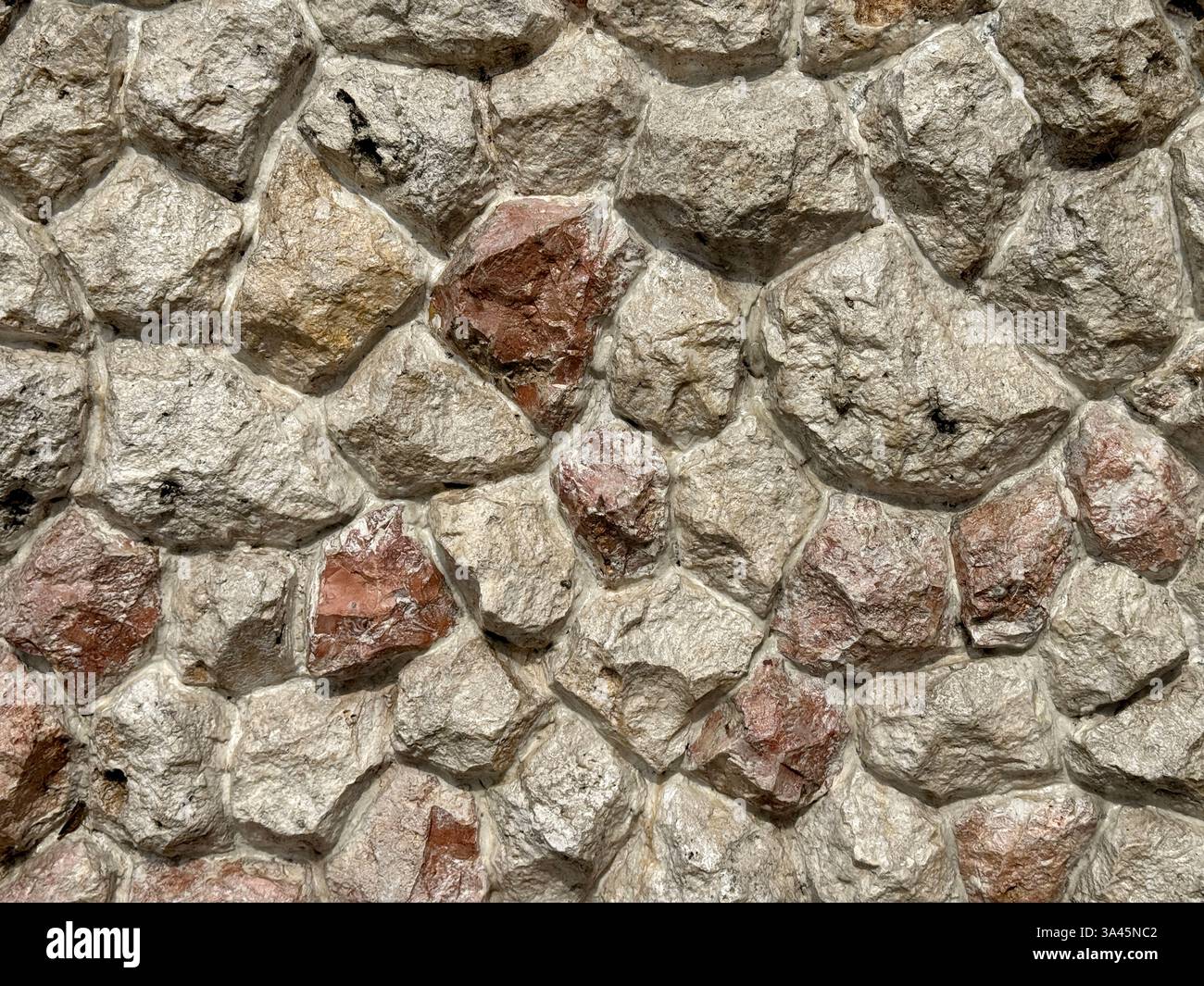 Natural beige cobble stone wall with slight red color and grunge ...