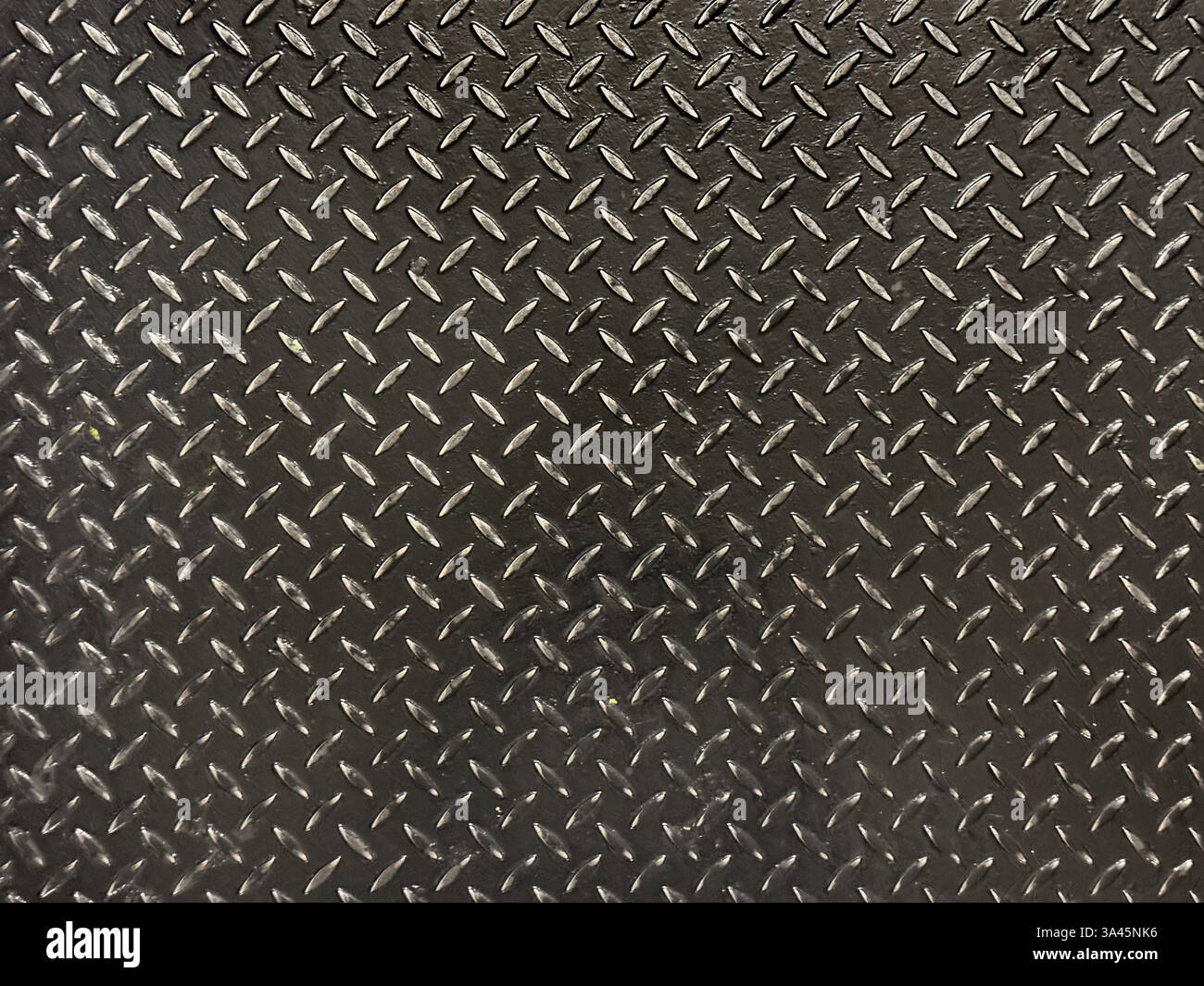 Close up of black metal checker plate or tread plate. Seamless tread ...