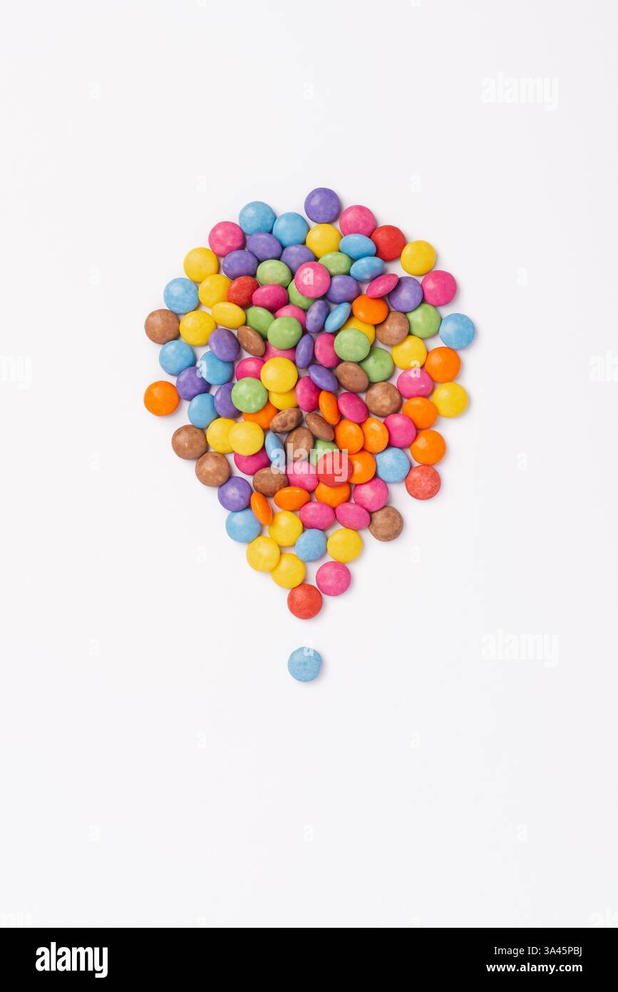 Brightly coloured sweets on white background. Rainbow colored candy ...