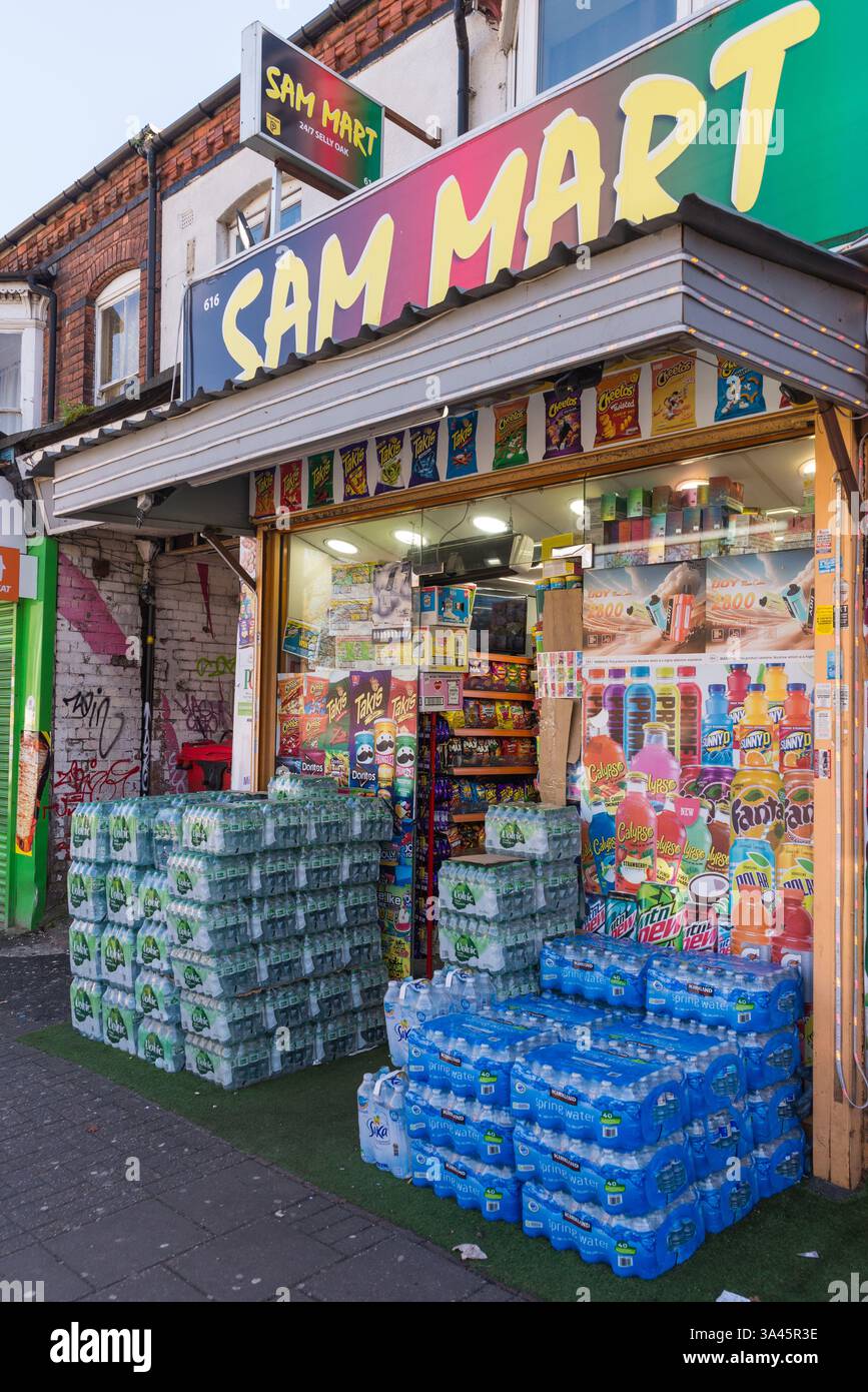A mini-market or convenience store with crates of bottled water outside ...