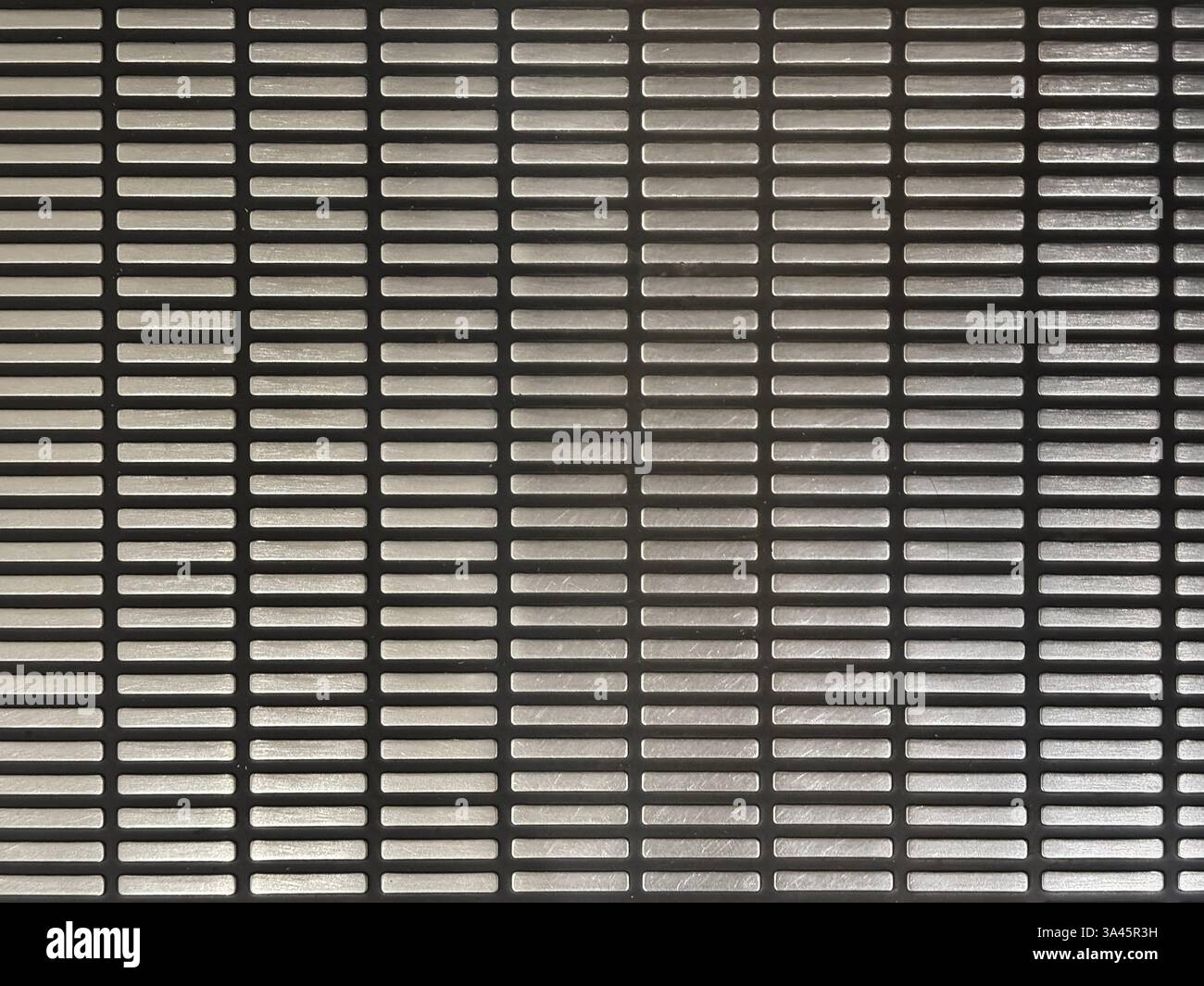 Close up of escalator landing metal plate with stripes and silver ...