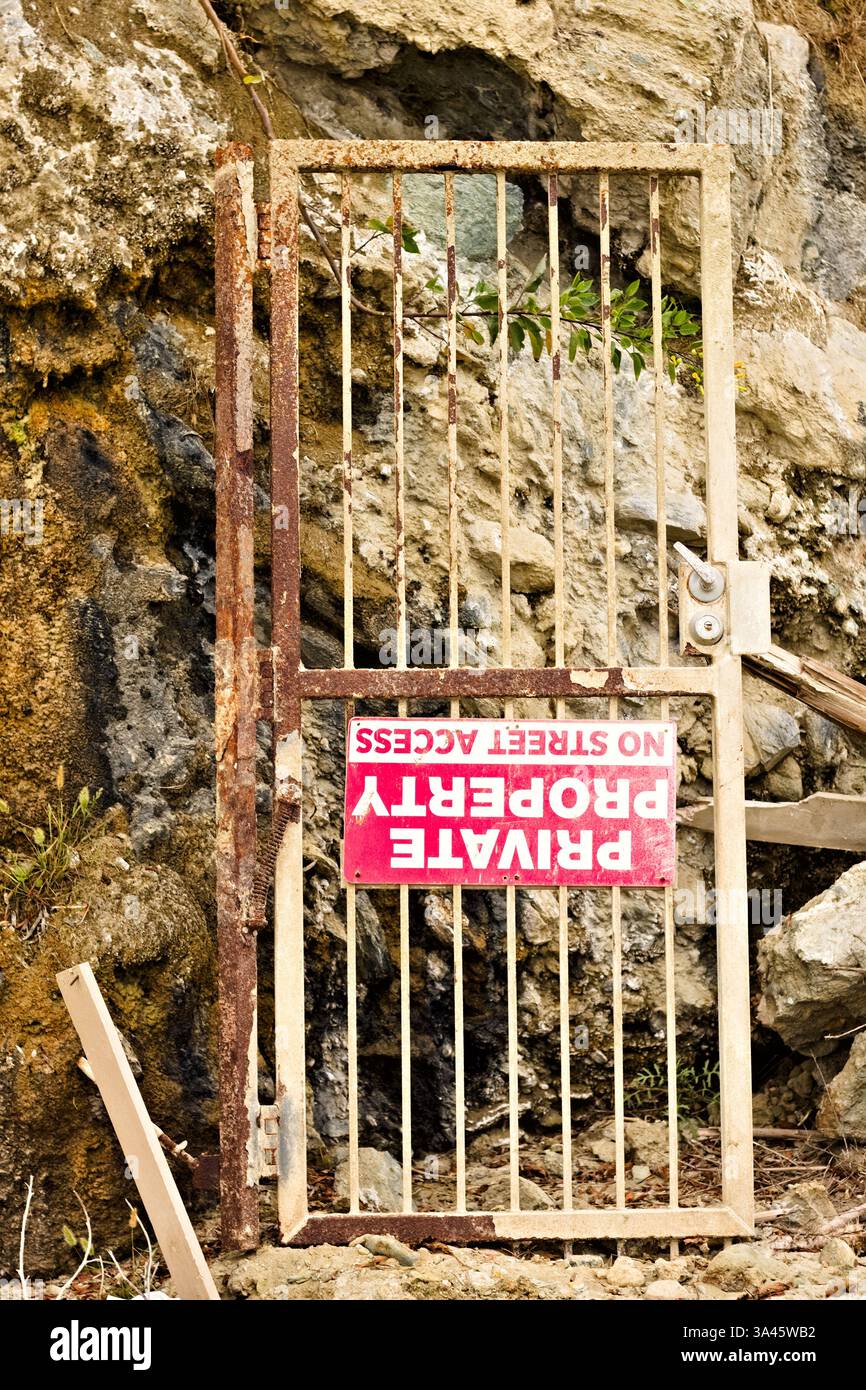 broken gate door at the base of a cliff Stock Photo - Alamy