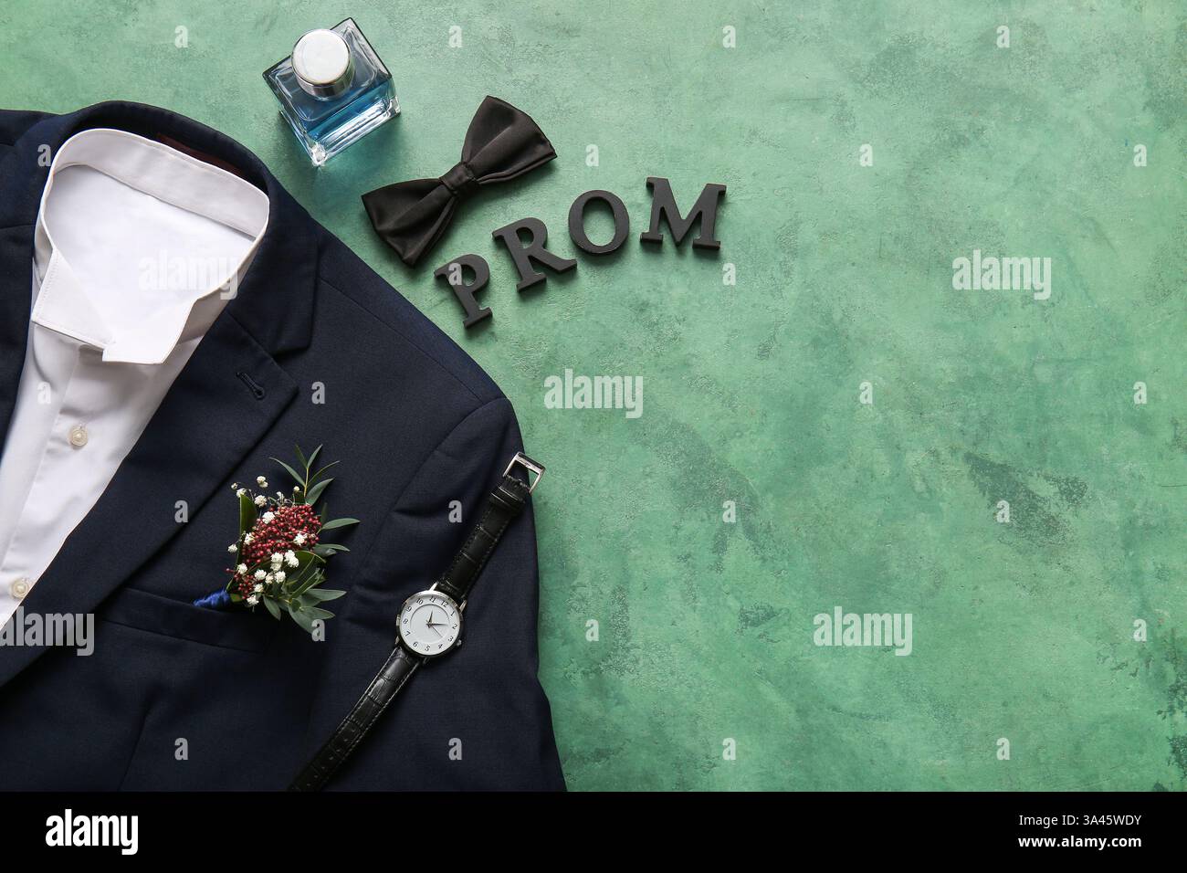 Word PROM, suit, wristwatch and perfume on green grunge background ...
