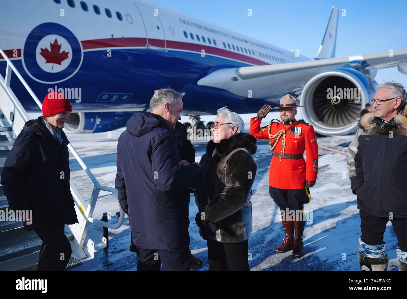Canada Prime Minister Mark Carney, centre, is greeted by Commissioner ...