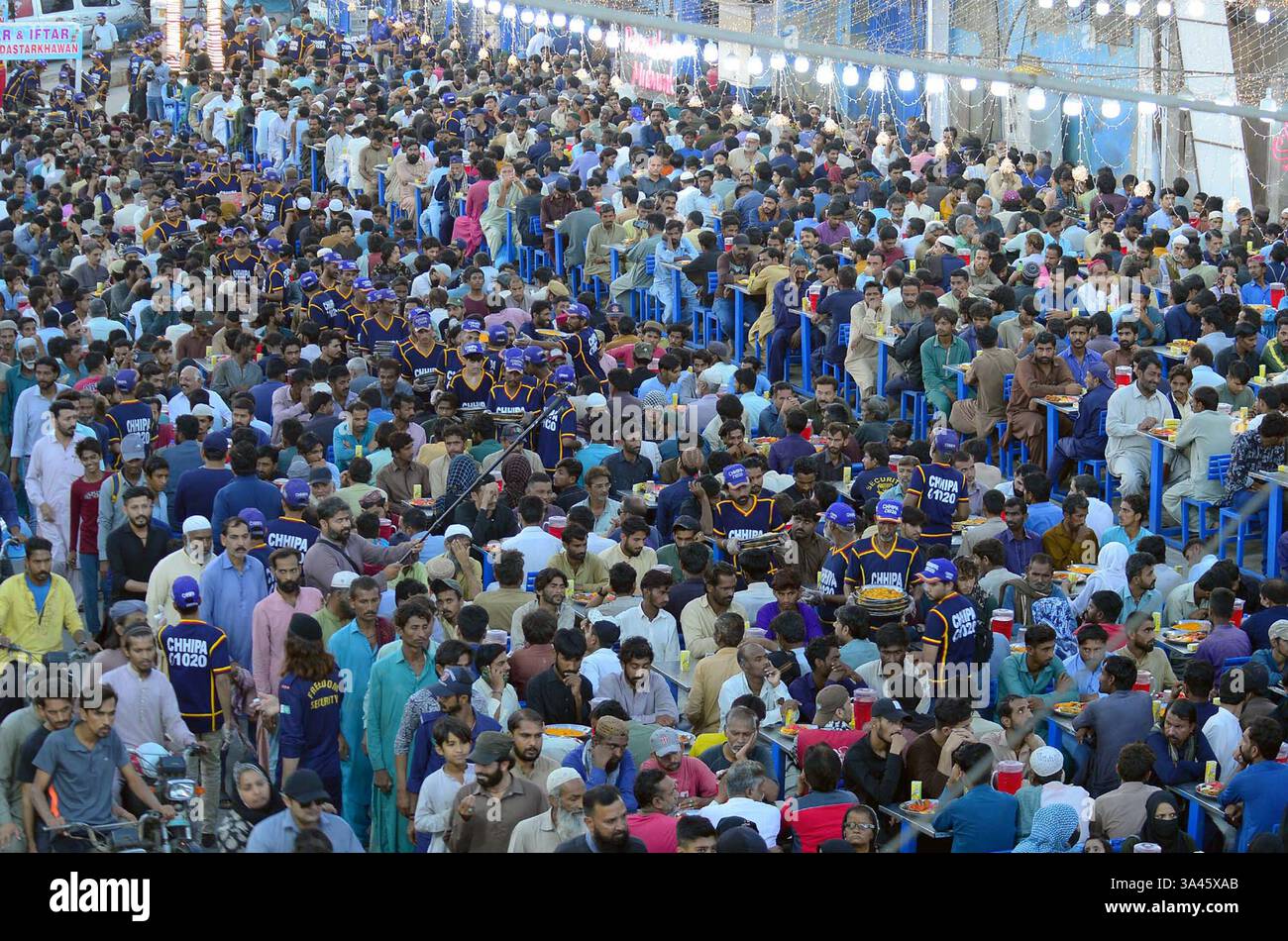 Faithful Muslims are breaking the fast (Iftar) under the supervision of ...