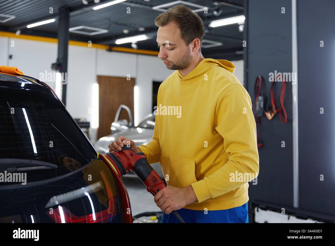 Professional serviceman providing professional detailing service in car ...