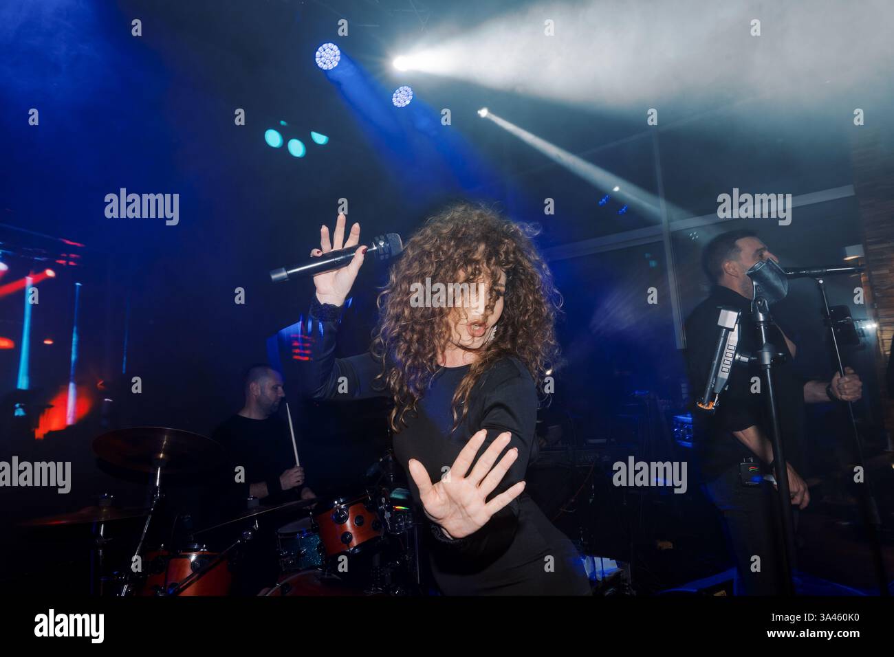 USA, Seattle - March 04, 2025: Singer with a microphone dances on stage ...