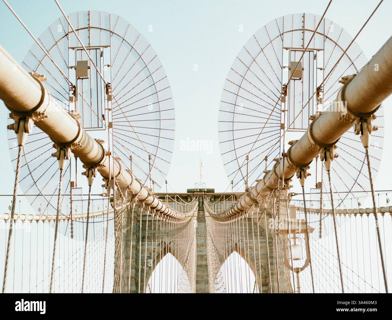 Cables stretch over stone towers of Brooklyn Bridge on a clear day ...