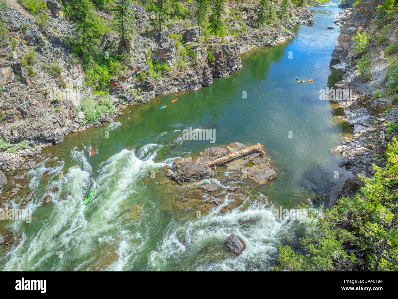 kayakers shooting fang rapids on the clark fork river in alberton gorge ...