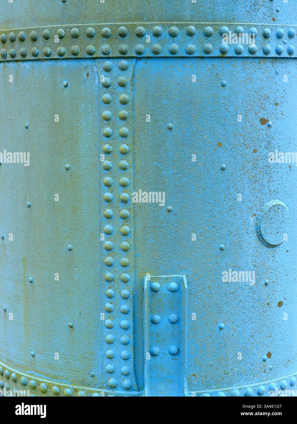 Light blue riveted metal wall of a tank with a striking retro look ...