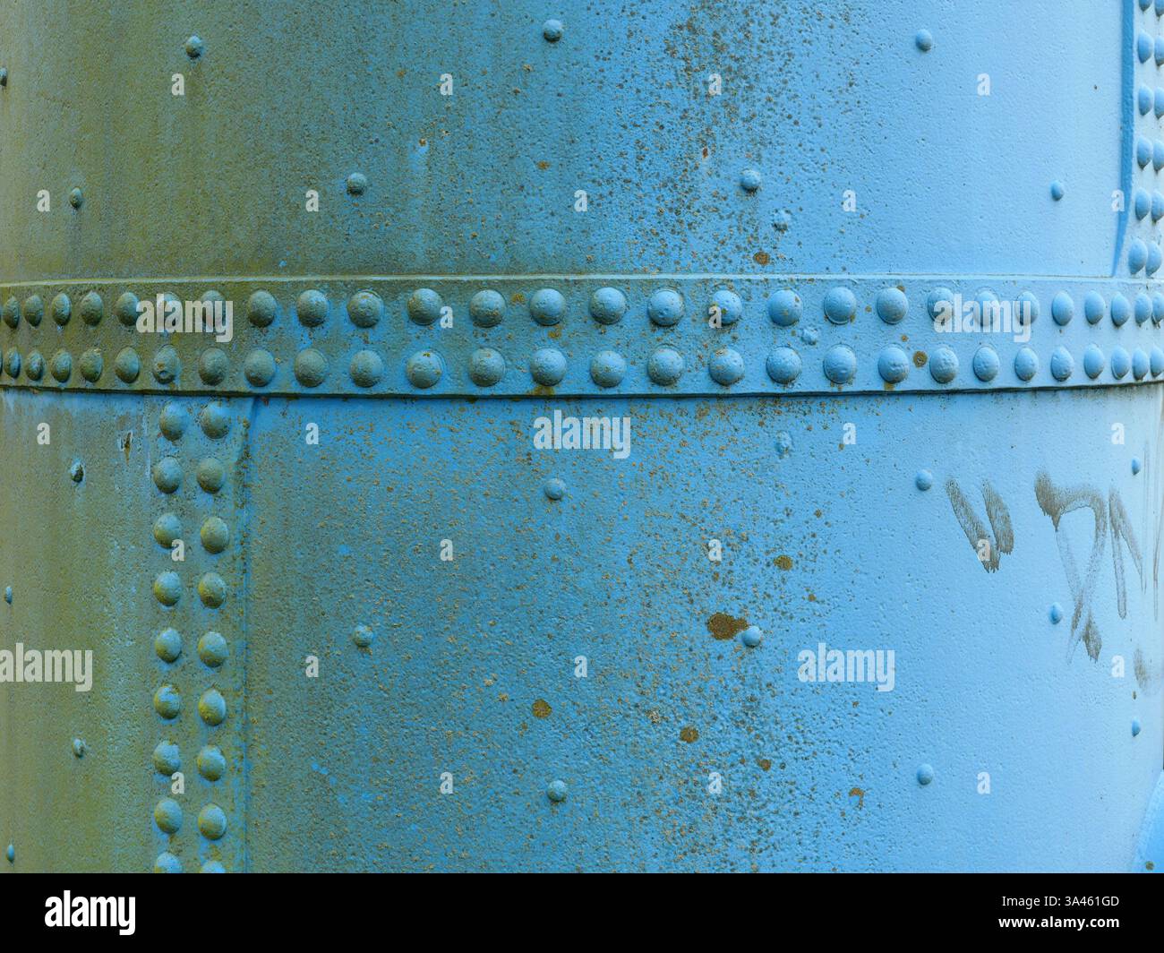 Light blue riveted metal wall of a tank with a striking retro look ...