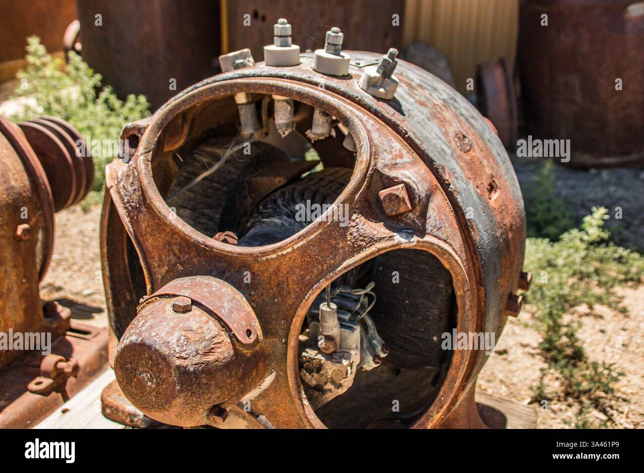 An old discarded broken and rusty electric motor once used in the ...