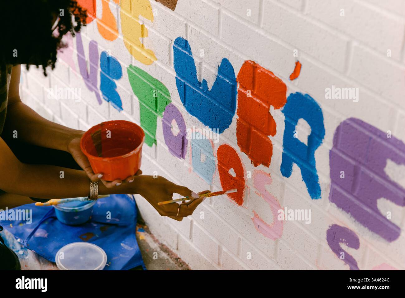 Participants engage in a mural painting project to promote unity ...