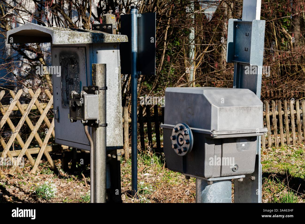 Utility boxes stand next to each other in a residential neighborhood ...